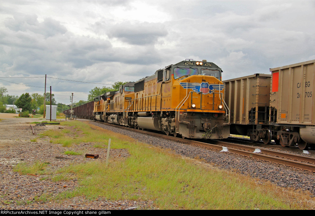 UP 4394 heads a Eb rock train past a wb coal.